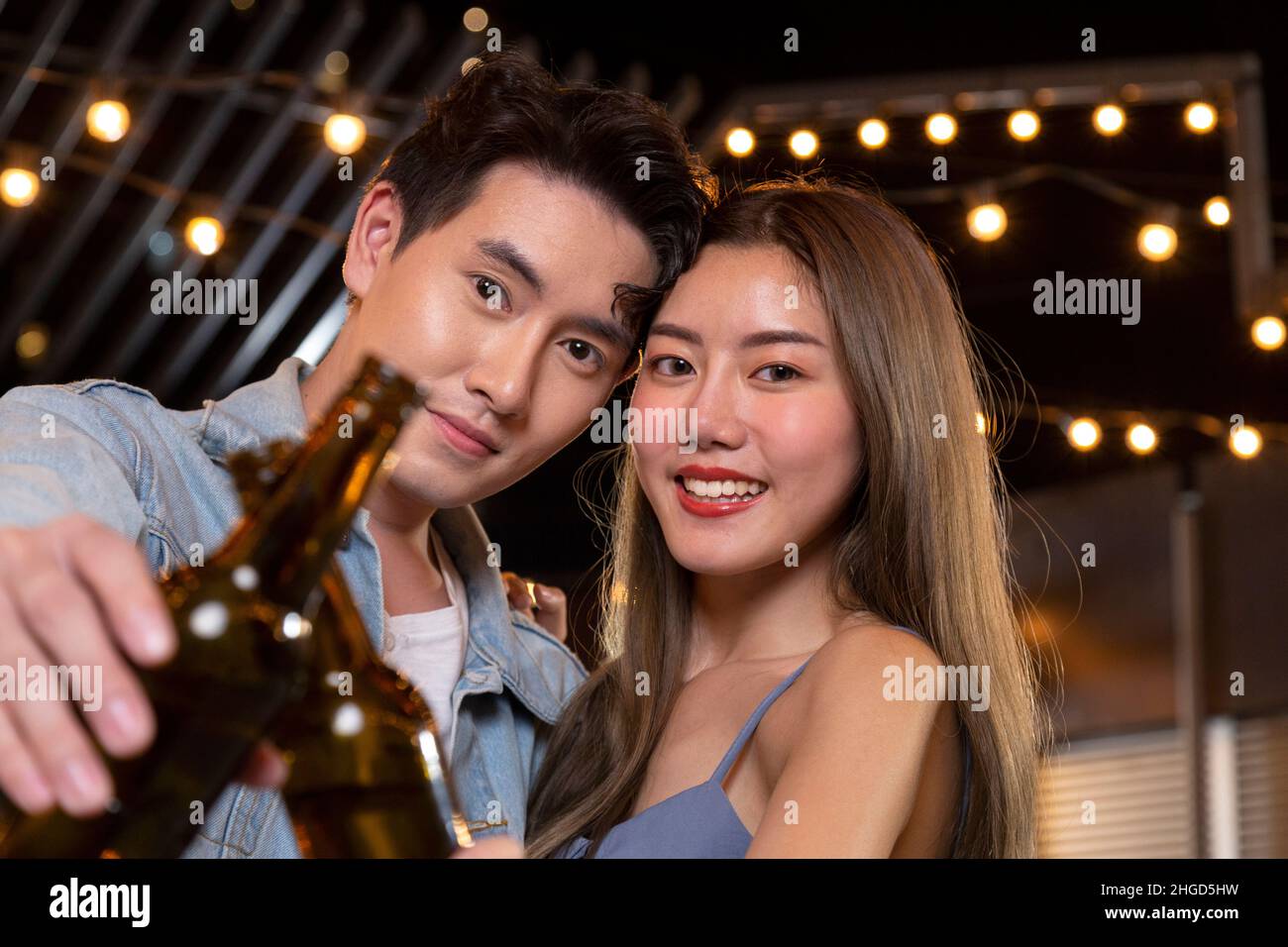 happy asian teenager couple man and woman in love drinking beer alcohol ...