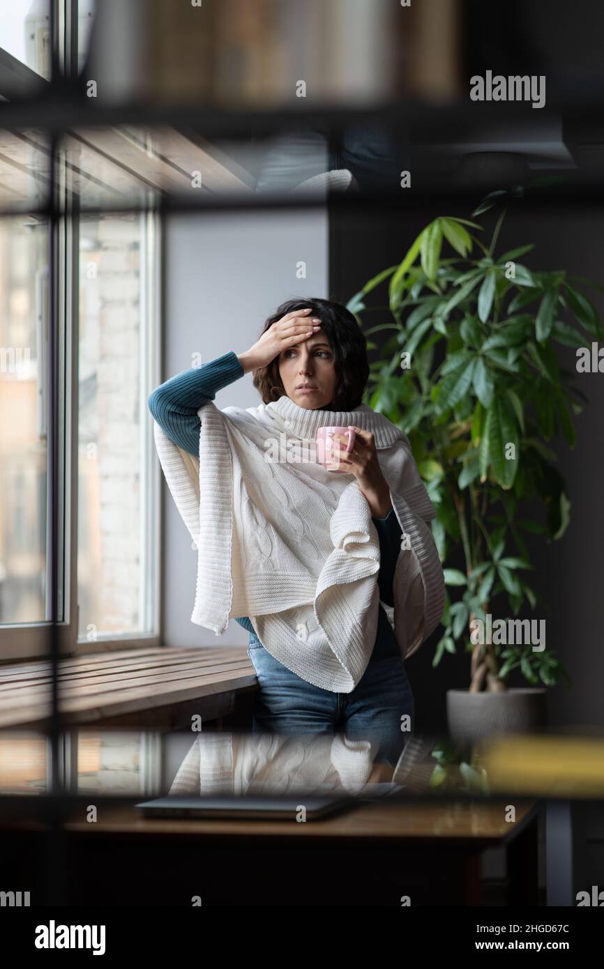 Sick young female employee with fever feeling unwell, unhealthy ...