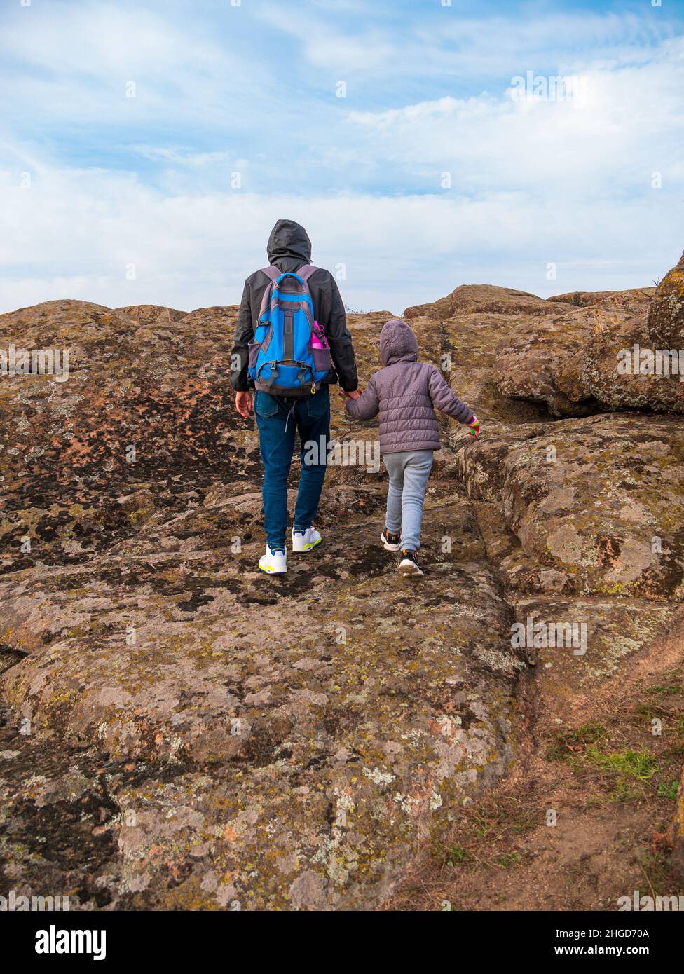 Travelers father and daughter walking climbing on mountain summit ...