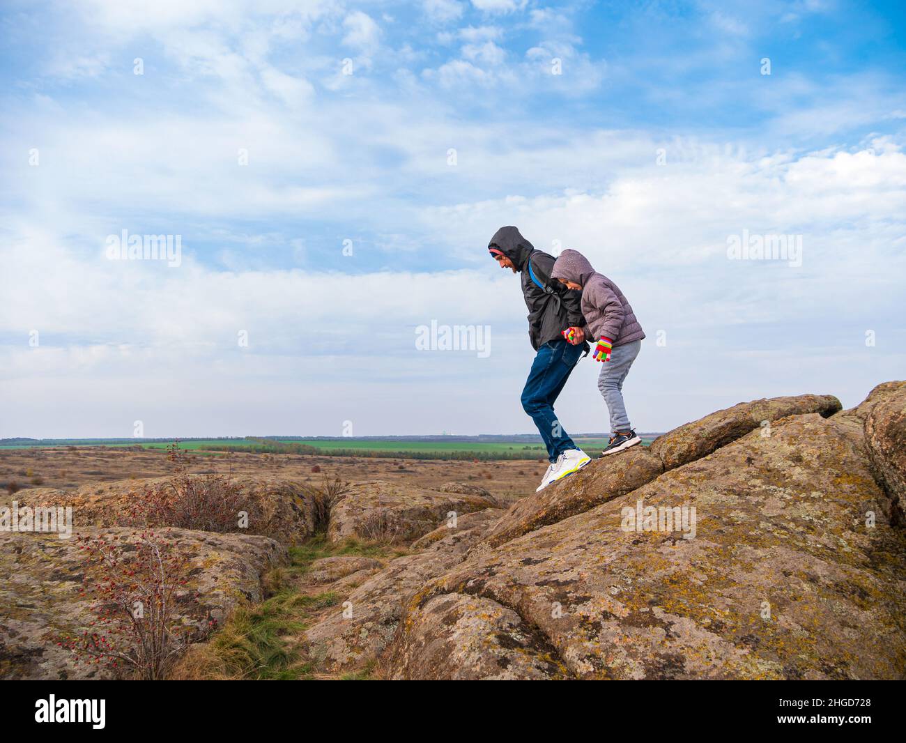Travelers father and daughter walking climbing on mountain summit ...