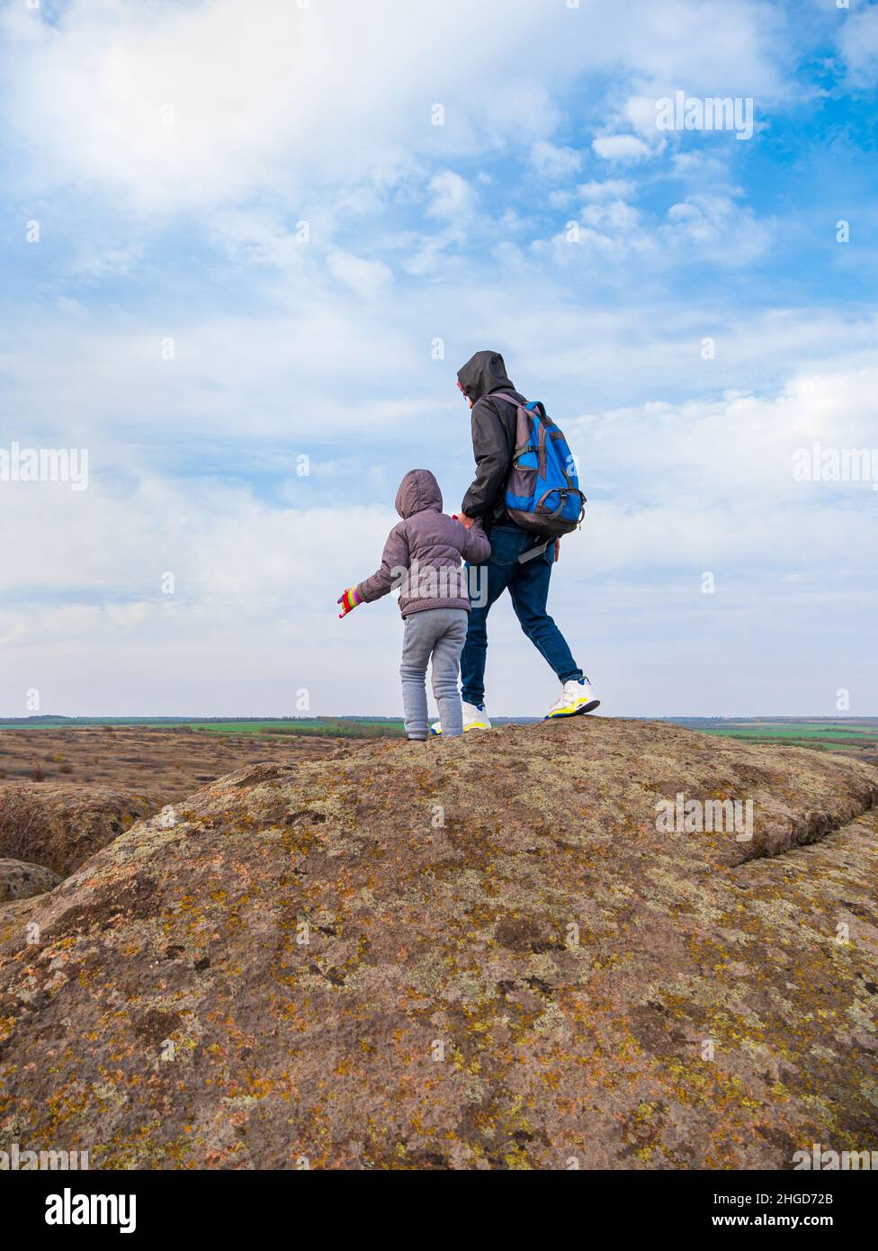 Travelers father and daughter walking climbing on mountain summit ...
