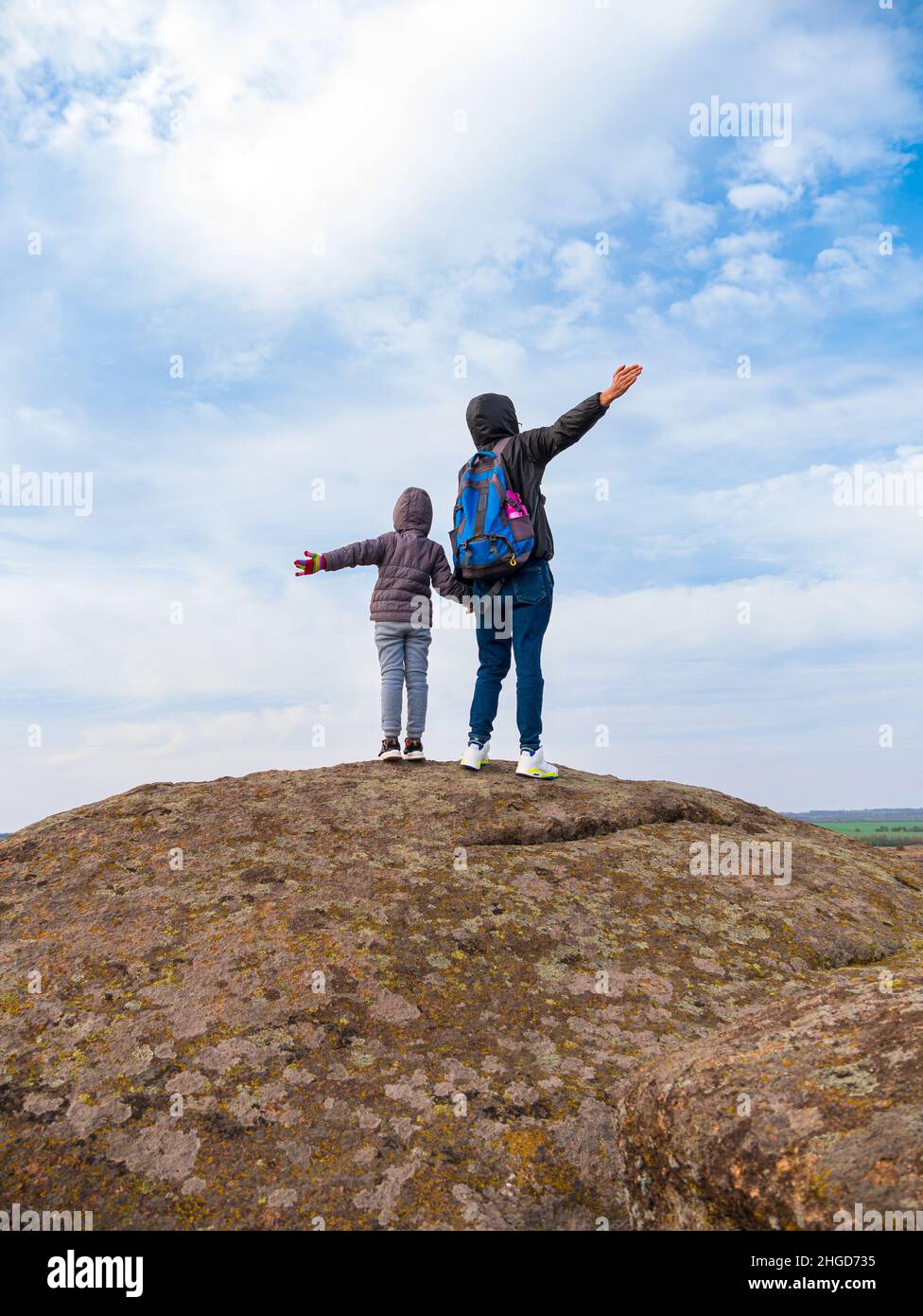 Travelers father daughter with raised hands walking climbing on ...