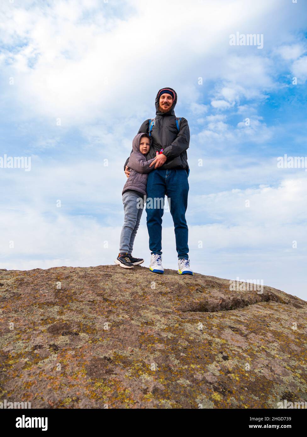 Travelers father and daughter walking climbing on mountain summit ...