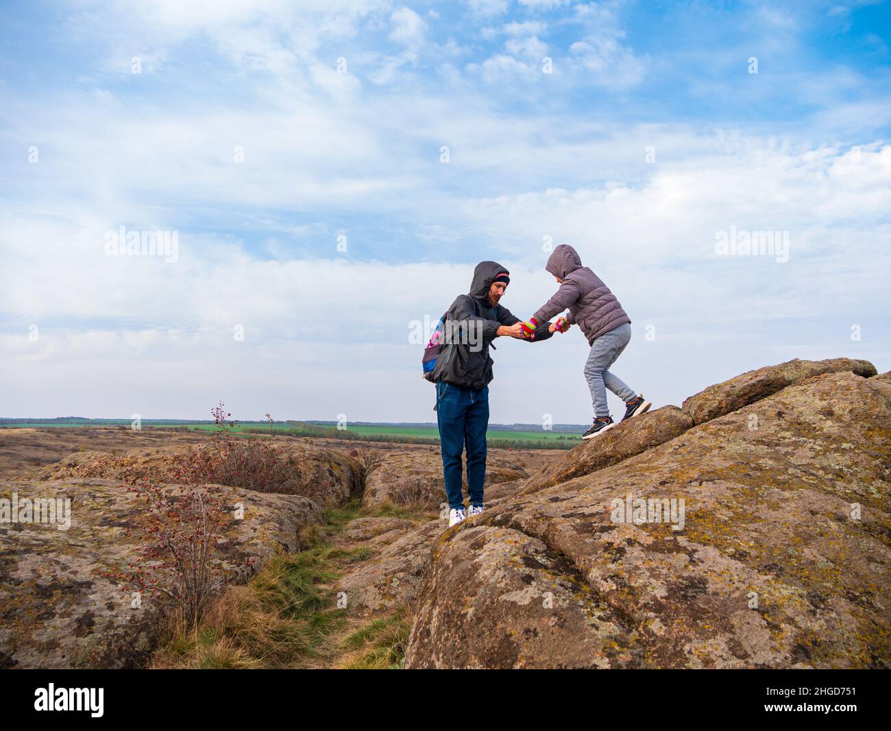 Travelers father and daughter walking climbing on mountain summit ...