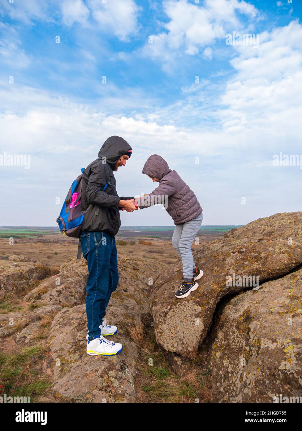 Travelers father and daughter walking climbing on mountain summit ...