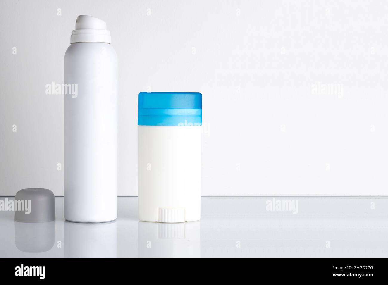 Spray and roll-on deodorant with blank label and reflection with plenty ...