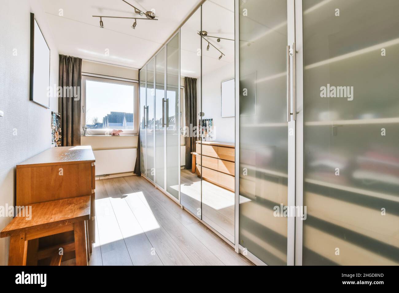 A stunning narrow long dressing room with a full-length wardrobe Stock ...