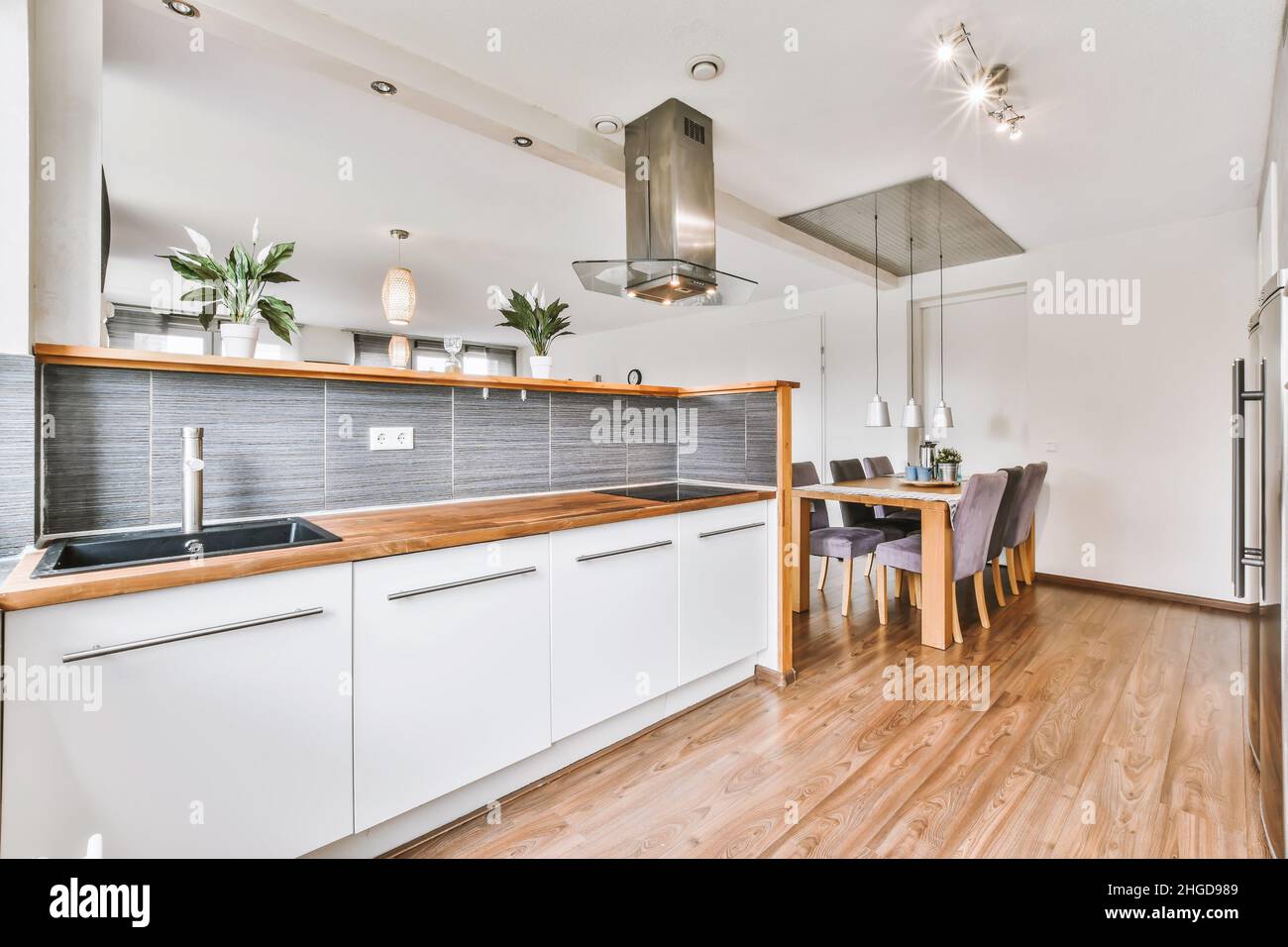 Lovely kitchen with wooden countertops and mirrored wall Stock Photo ...