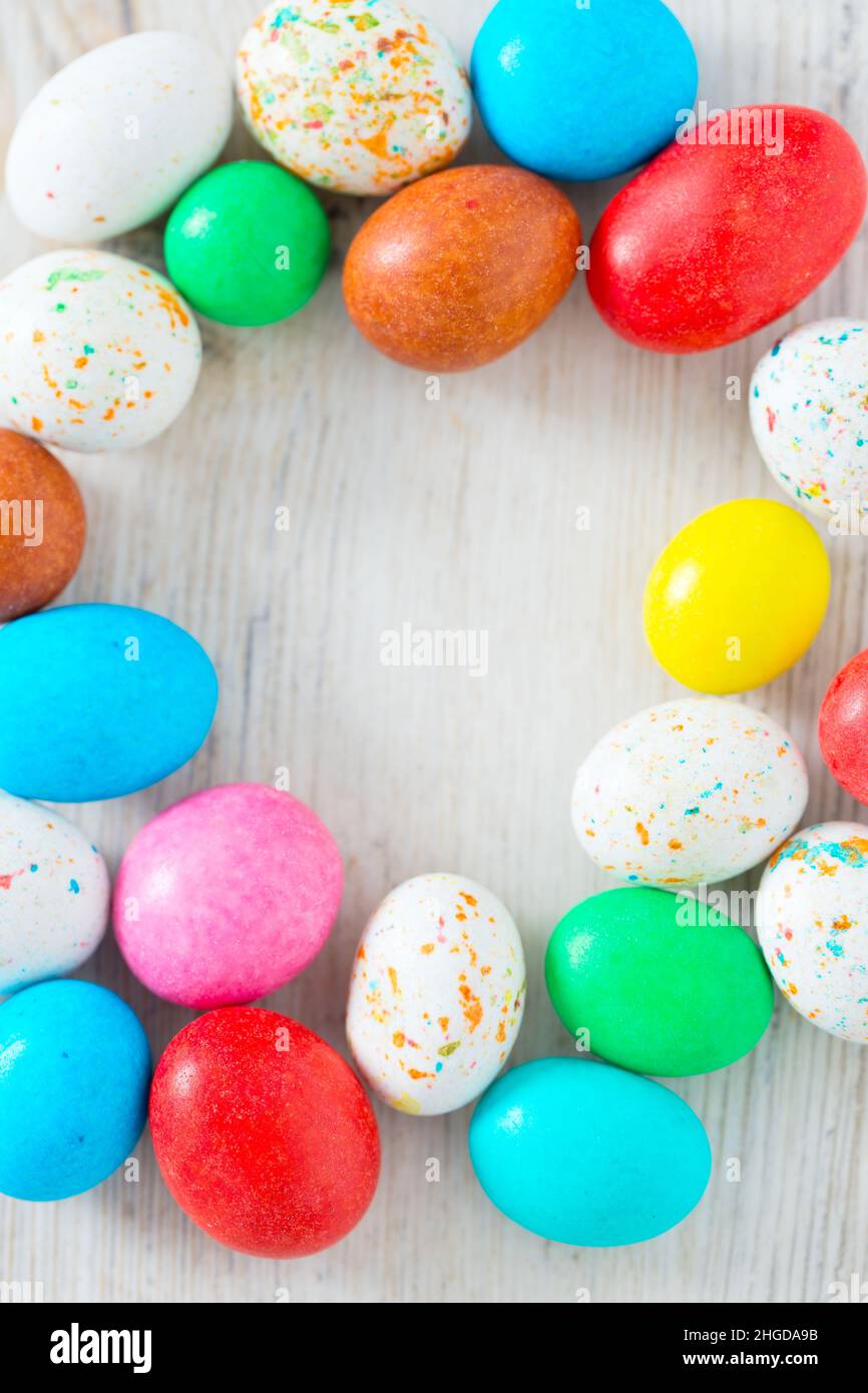 Easter candy eggs on white wooden surfae Stock Photo - Alamy