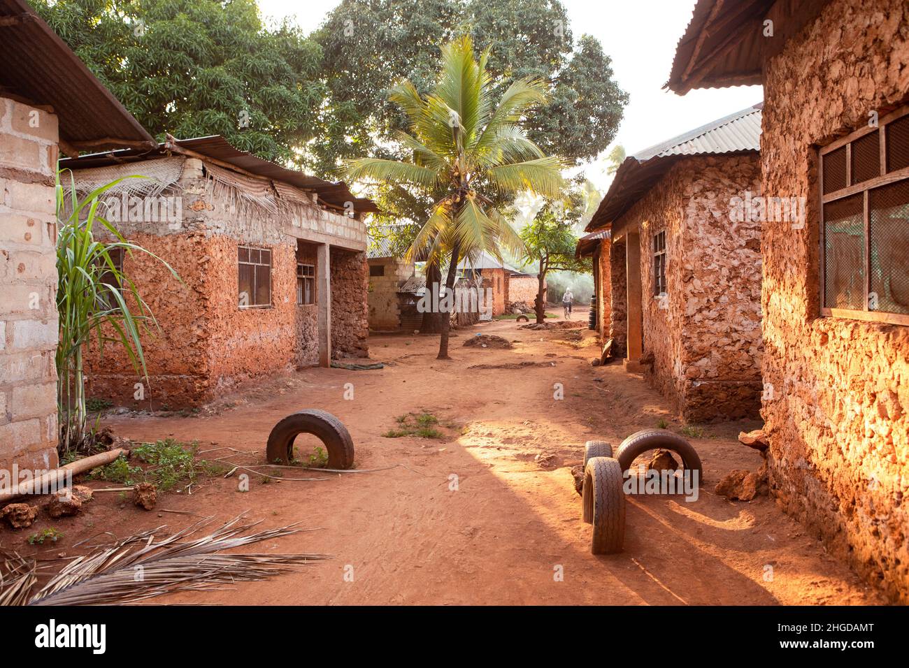 View on african village with palm. Street full of light, vibrant red ...