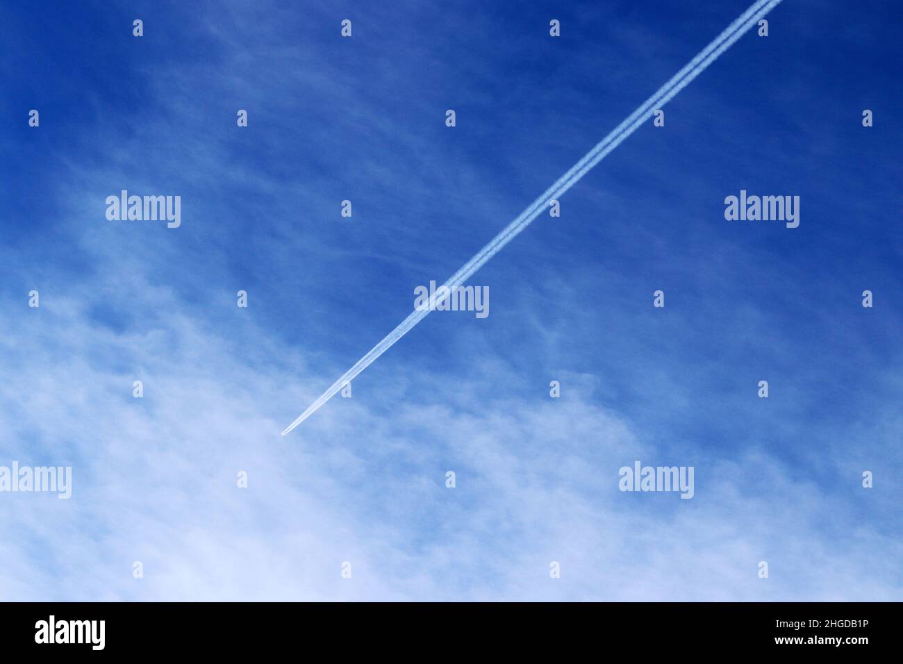 Trace of the high flying plane on the blue sky with white clouds Stock ...