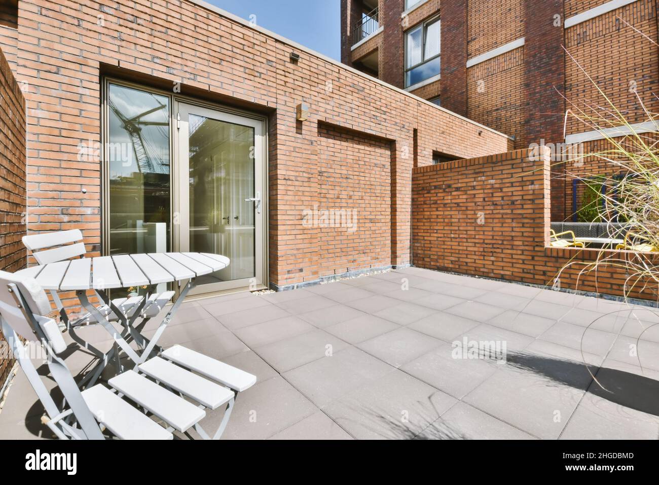 Stylish courtyard of a chic house with brick walls Stock Photo - Alamy
