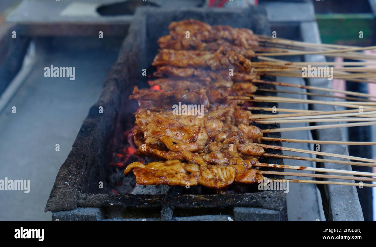 Satay - chicken satay being grilled Stock Photo - Alamy