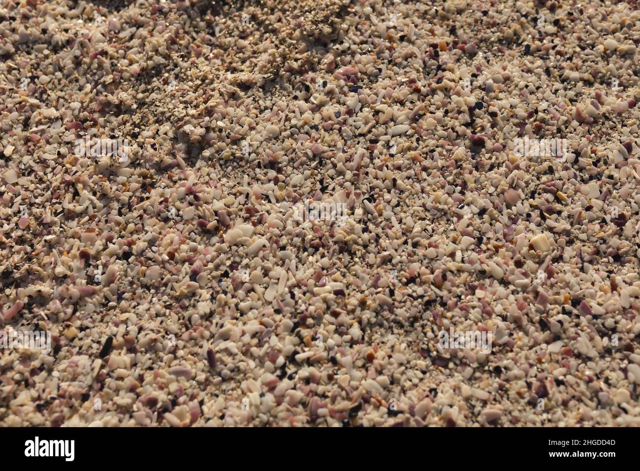Overhead full frame view of sand grains with rough texture at beach ...