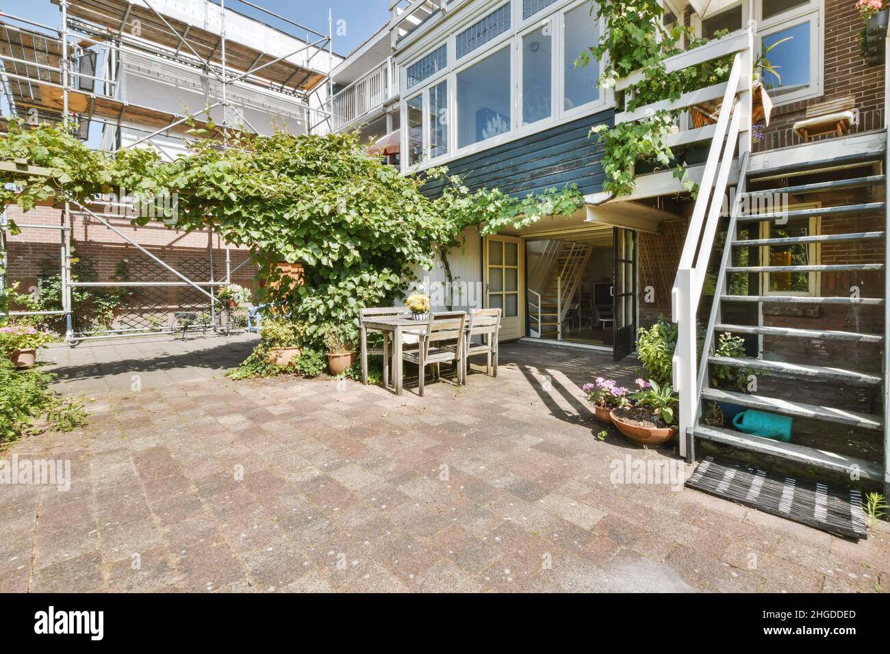 Attractive courtyard of the house with stairs and lots of flowers Stock ...