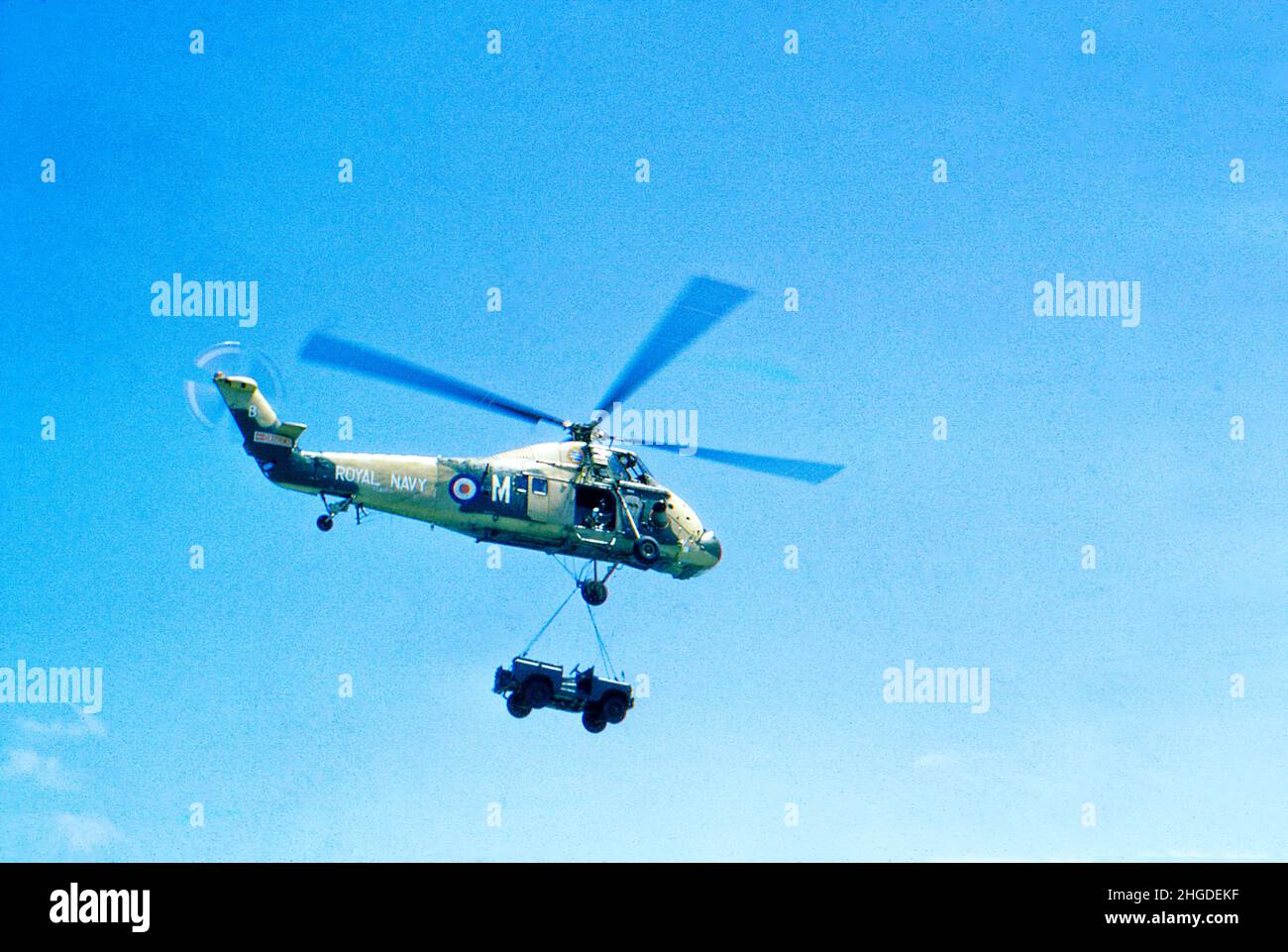 Royal Navy Wessex 2 helicopter off loading vehicles from HMS Bulwark ...