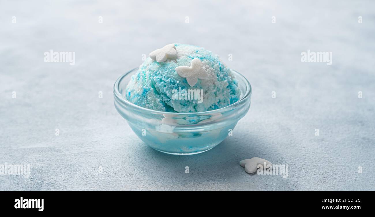 Blue ice cream close-up on a gray background. Blueberry ice cream. Side ...