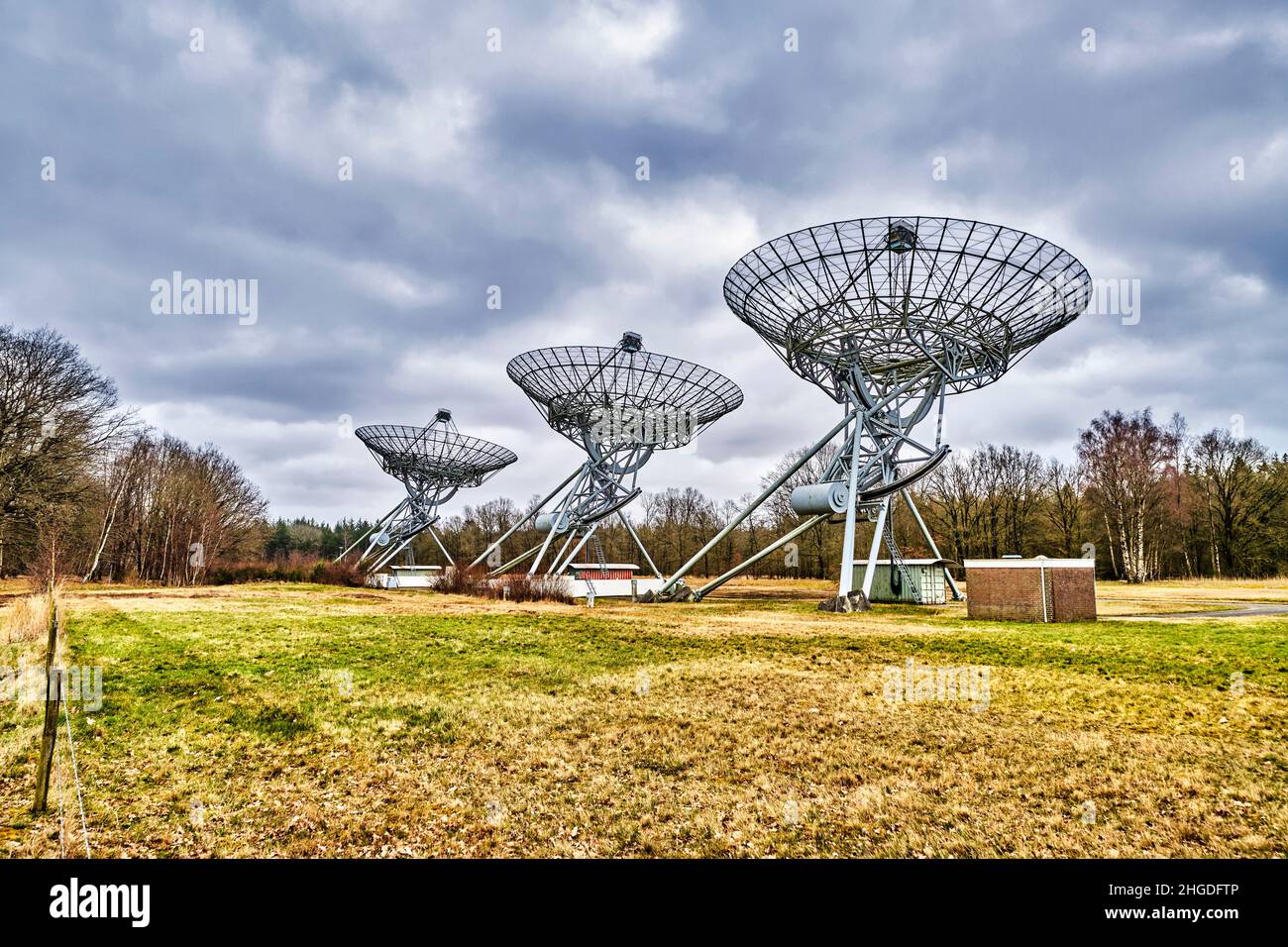outer space radio telescope array, with a forrest in the background ...