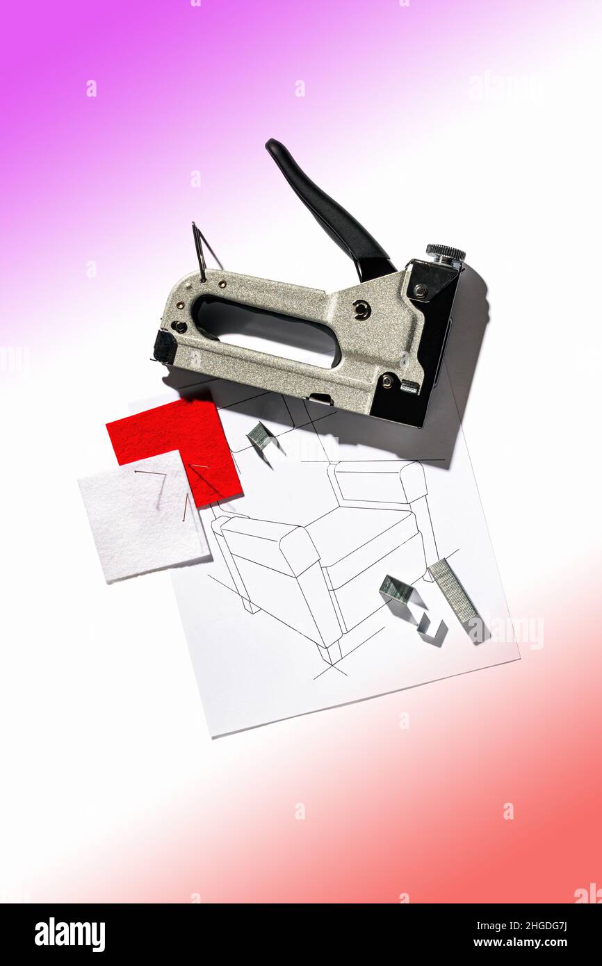 Silver furniture stapler gun with staples and the drawing of the ...