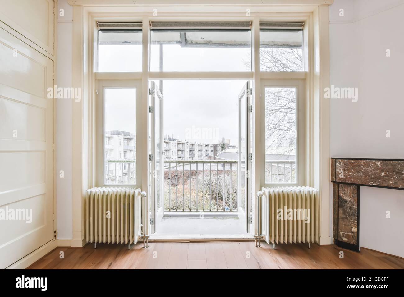 Open doors leading to a balcony with a radiator on both sides Stock ...