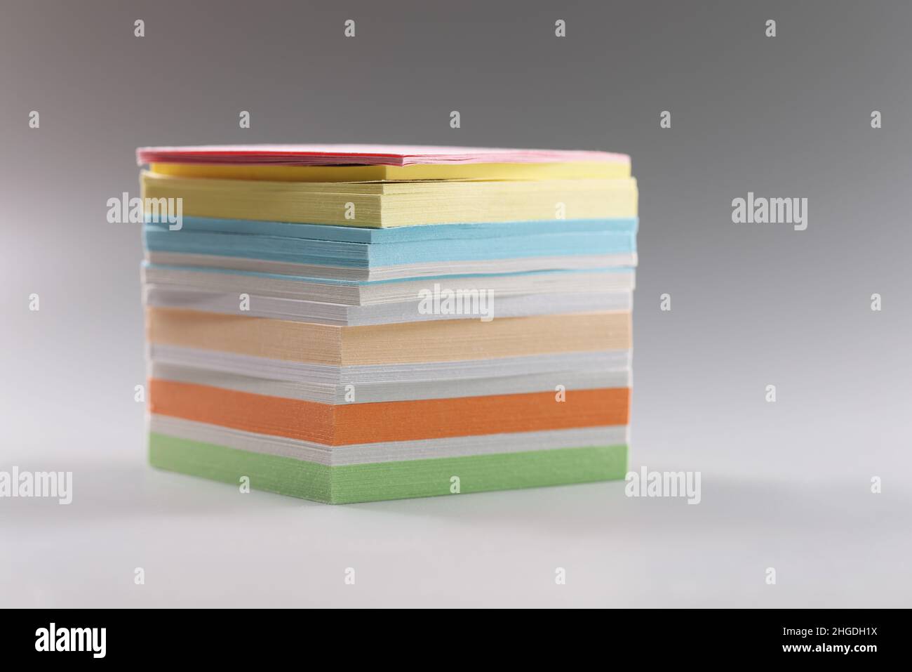 Uneven stack of sticky post it notes on grey surface, bunch of clean ...