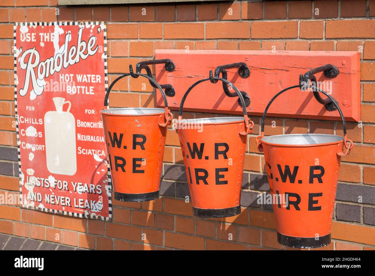 Emergency red fire buckets (vintage GWR) hanging outdoors on the ...