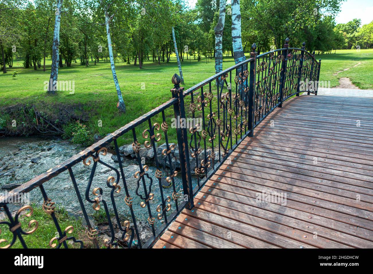Footbridge over the brook . Wooden pedestrian bridge in the park ...
