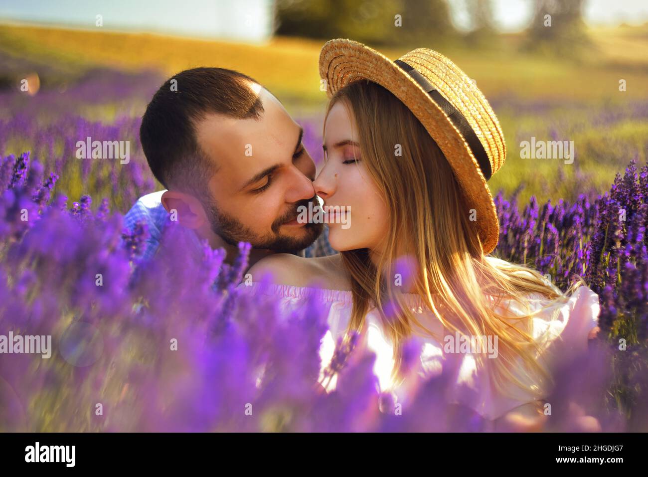 Cute young couple in love in a field of lavender flowers. Enjoy a ...