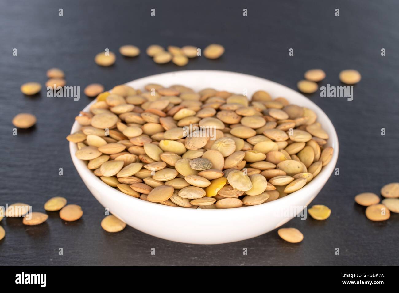 Dry organic green lentils in a white saucer on a slate stone Stock ...