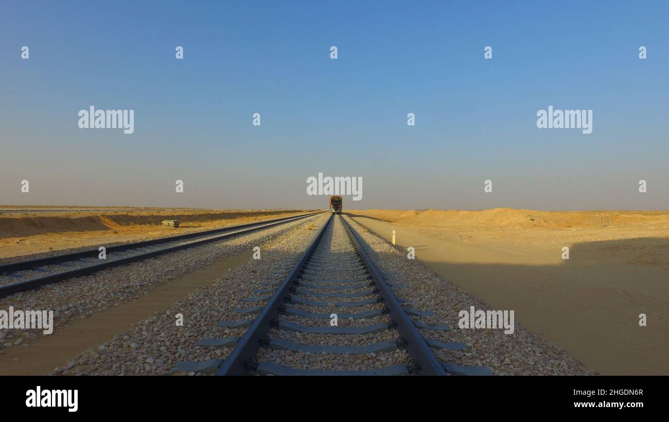 train rail in the desert and the train approaching from far away Stock ...