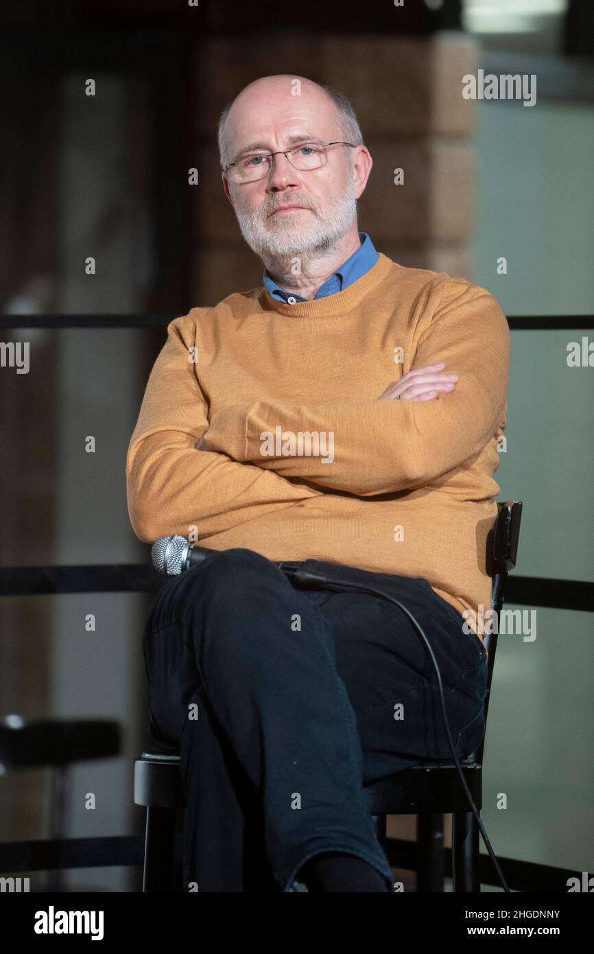 Harald Lesch with arms given away during the panel discussion with the ...