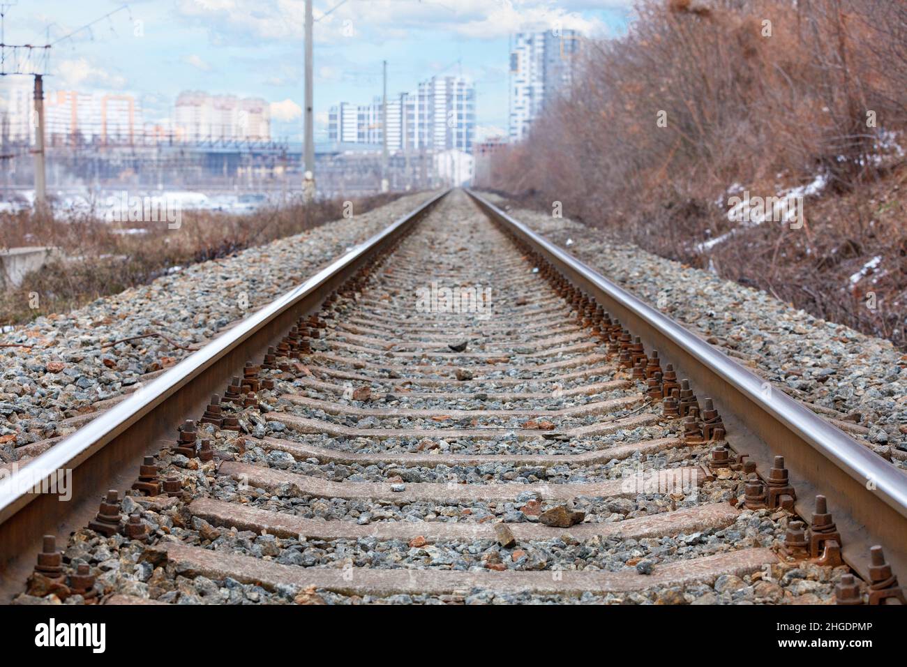 Parallel rails converging with each other against the backdrop of a ...