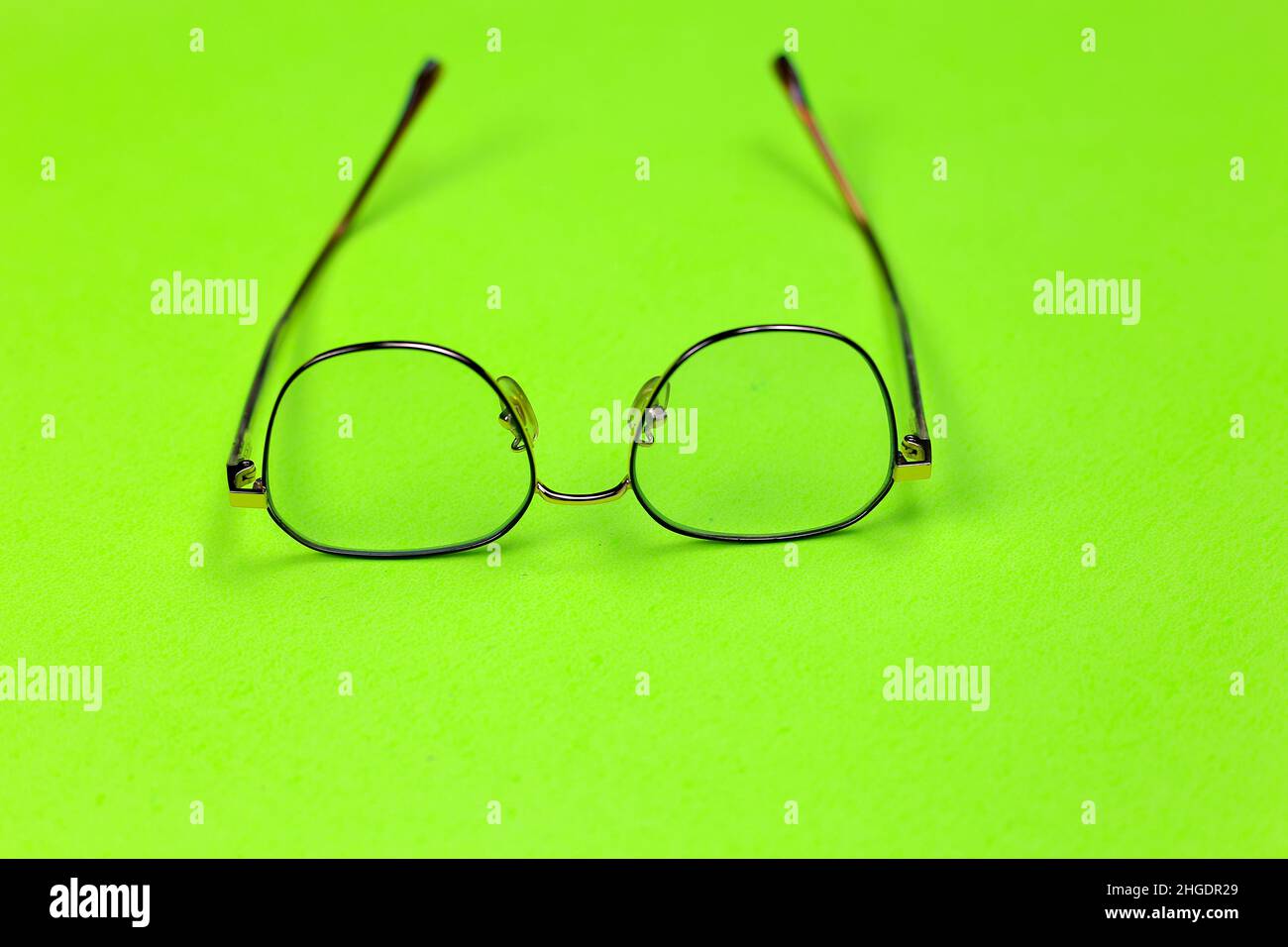 glasses with transparent lenses on a green background Stock Photo - Alamy
