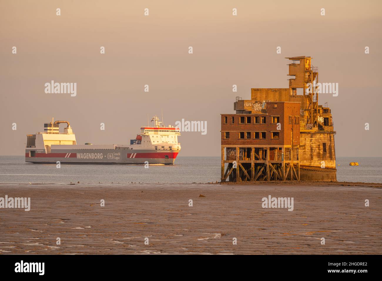 Cargo boat travelling up the Medway from the Thames. Passing Grain Fort ...
