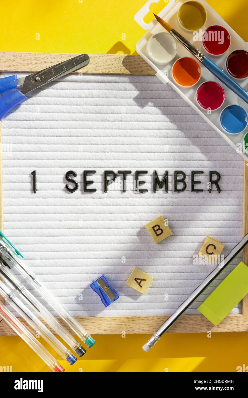 1 september letter board with school supplies as pens, scissors, ABC ...