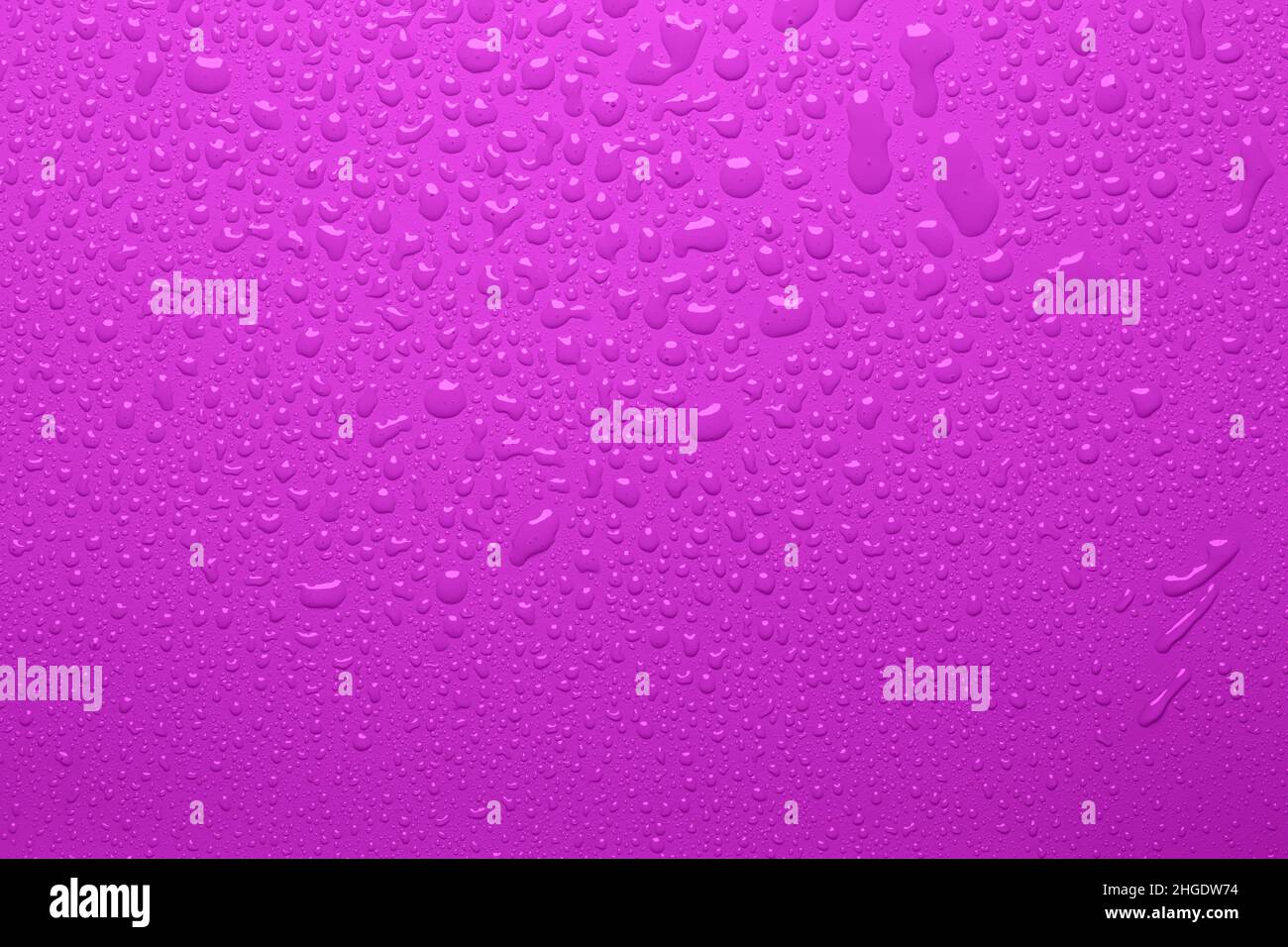 Water drops on pink color surface Stock Photo - Alamy