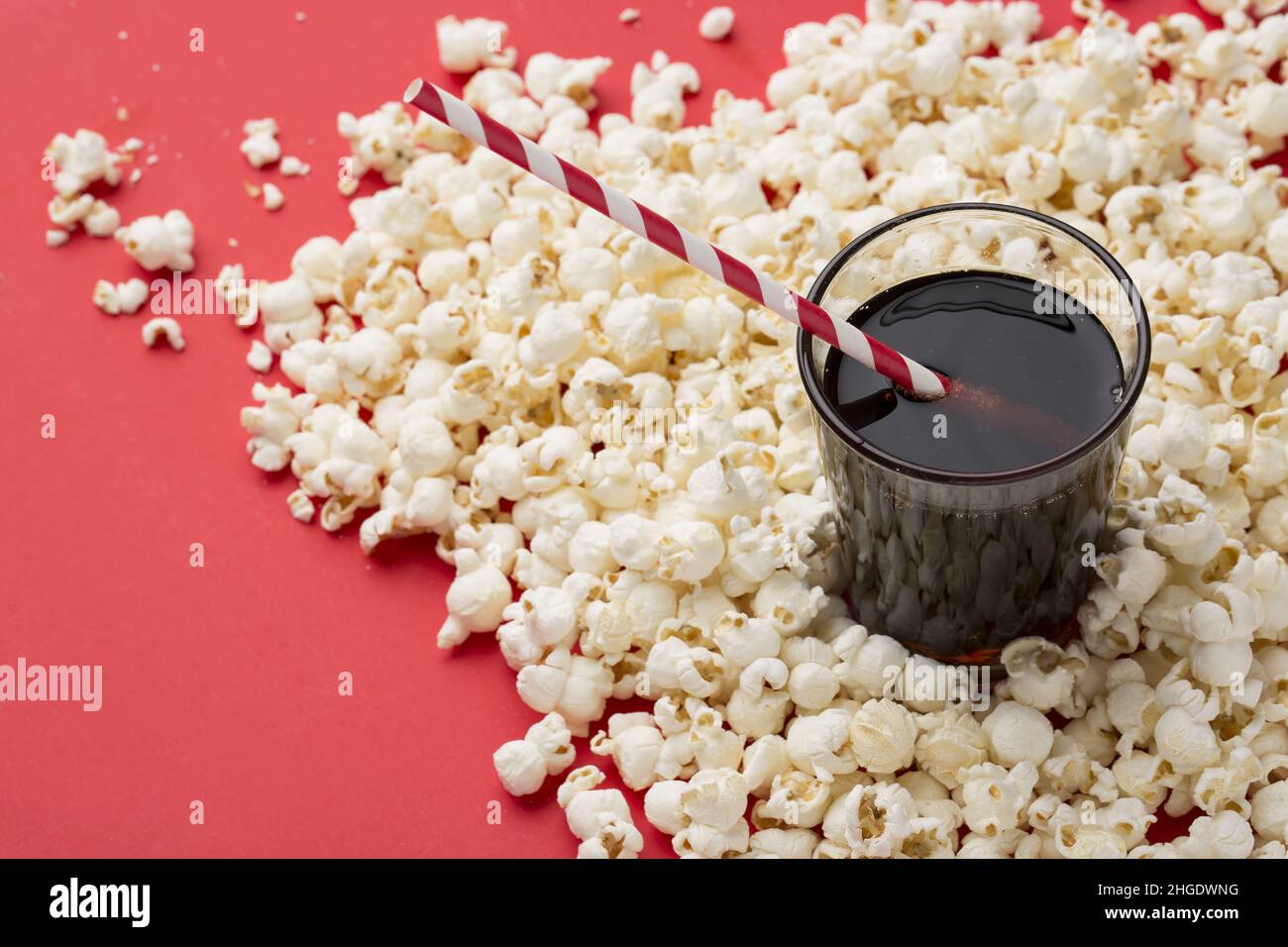 popcorn on red textured background Stock Photo - Alamy