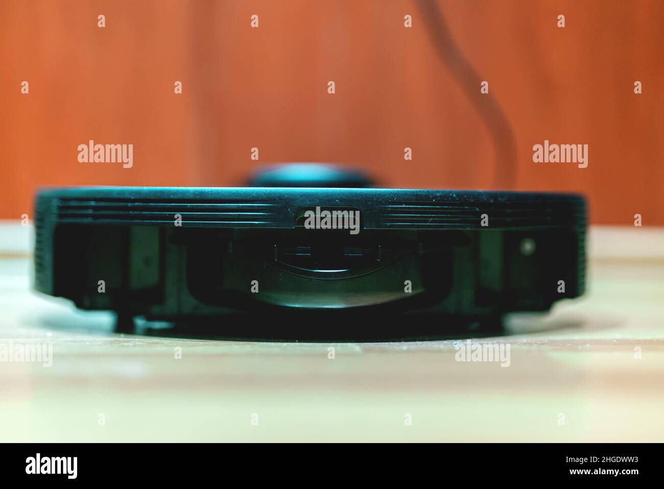 Robot vacuum cleaner is charged at the base Stock Photo - Alamy