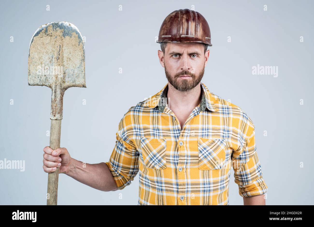 man laborer in construction safety helmet and checkered shirt on ...