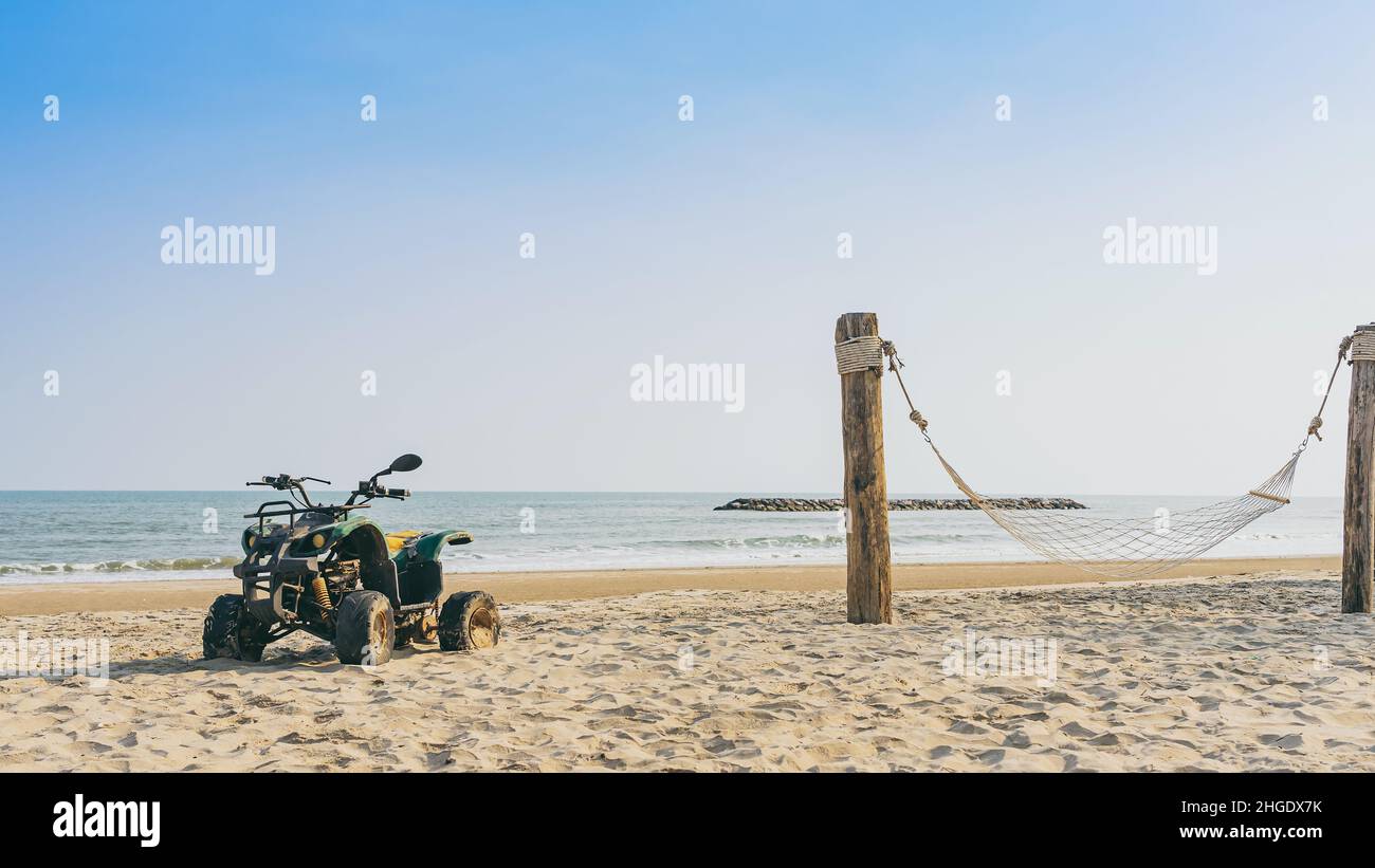 Vintage green ATV on the sandy beach. Quad ATV all terrain vehicle ...