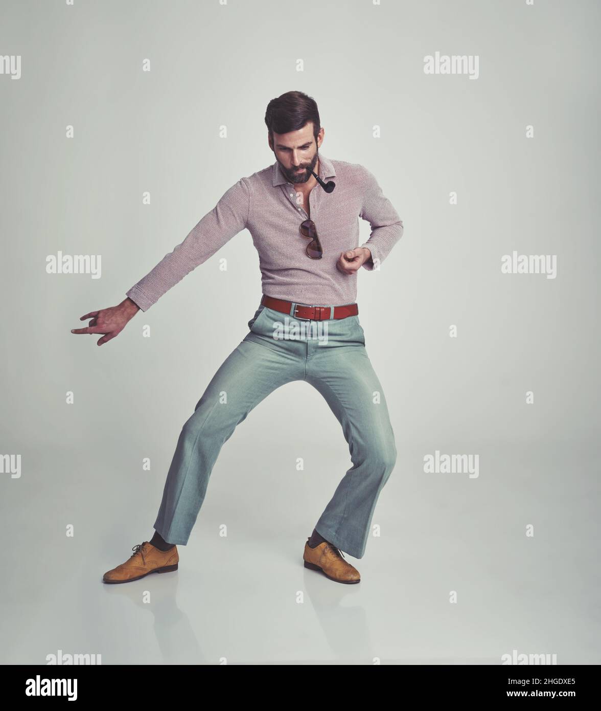 Goofy and groovy. Studio shot of a man in 70's style clothing Stock ...