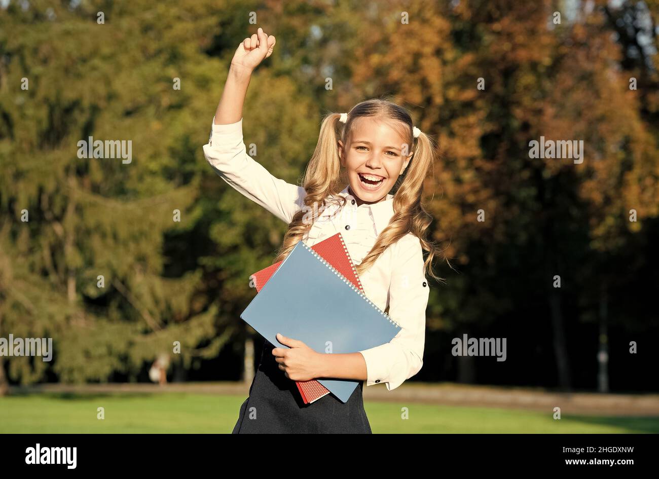 Excellent student girl study with school book outdoors, successful ...