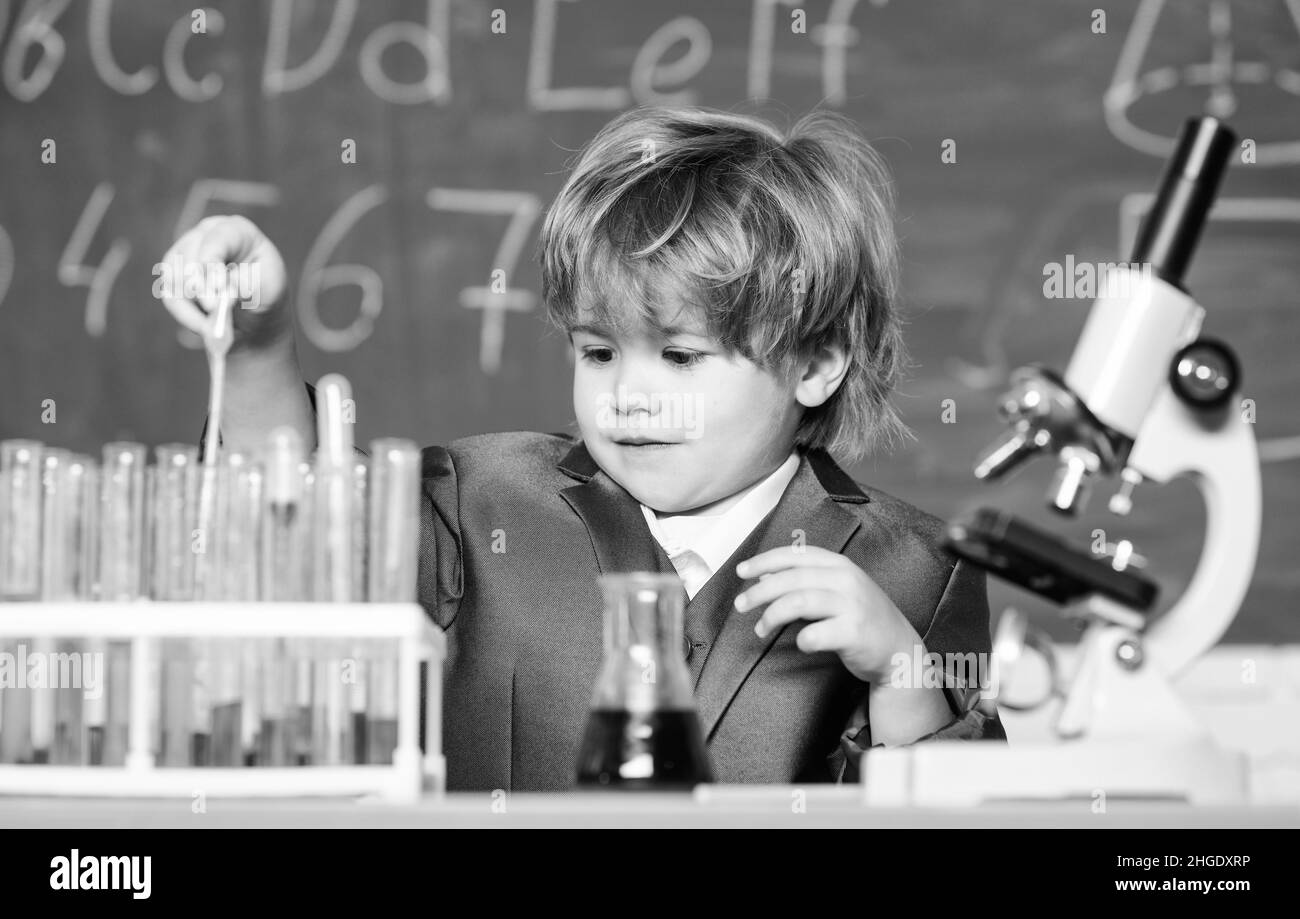 small boy using microscope at lesson. microscope at lab. Back to school ...