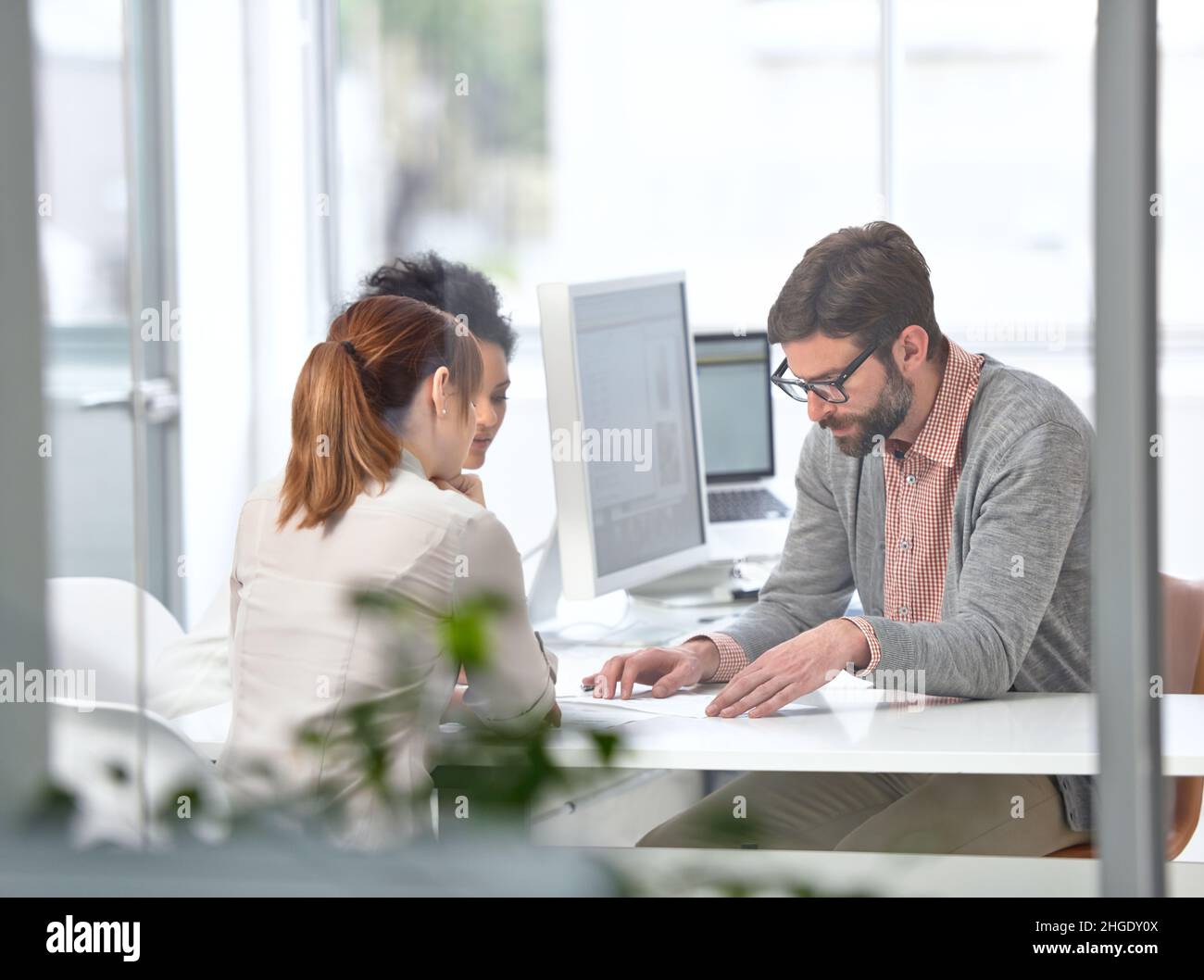 Teamwork gets business done. A group of businesspeople going over some ...