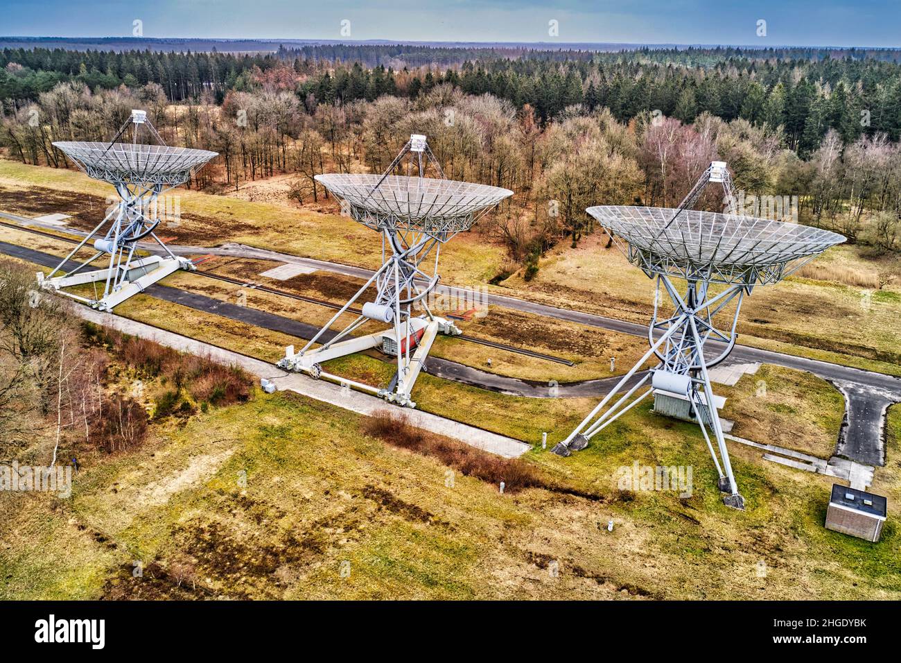 outer space radio telescope array, with a forrest in the background ...