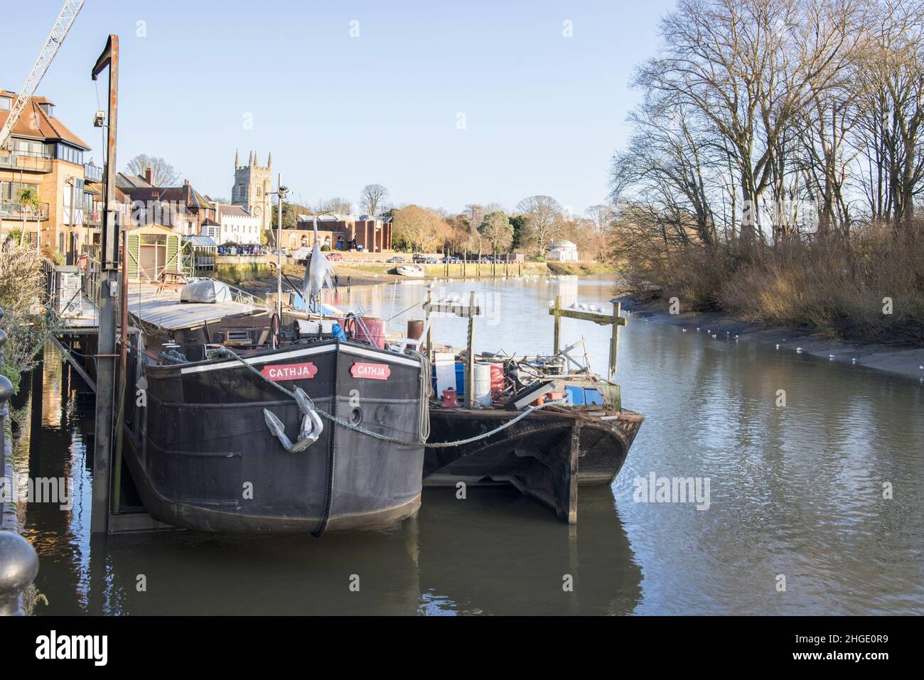 barges moored on the banks of the river thames at old isleworth in the ...