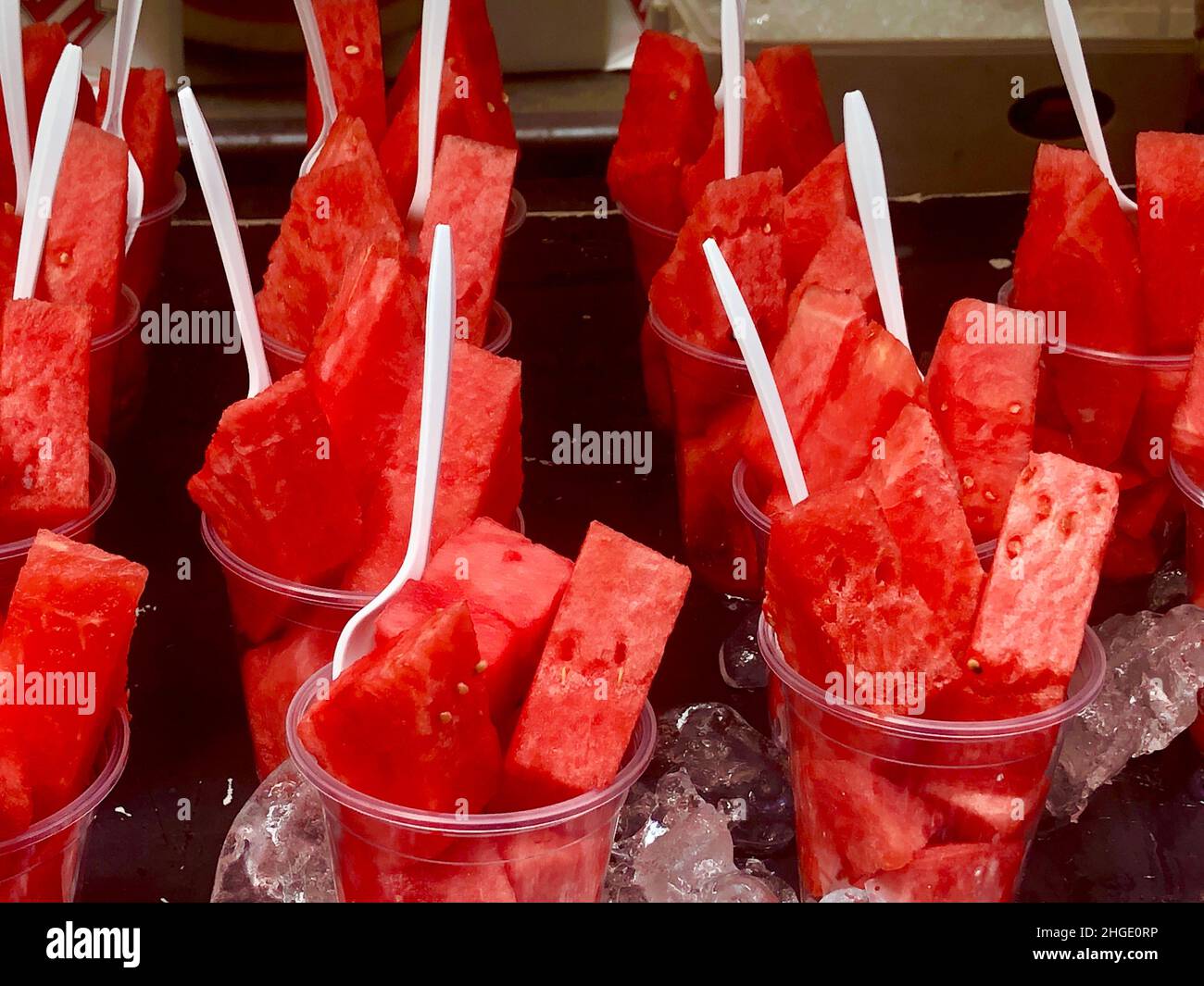 Watermelon chunks served in plastic cups with forks Stock Photo - Alamy