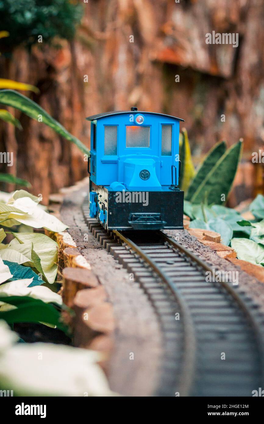 Blue model train on a track in a holiday display Stock Photo - Alamy