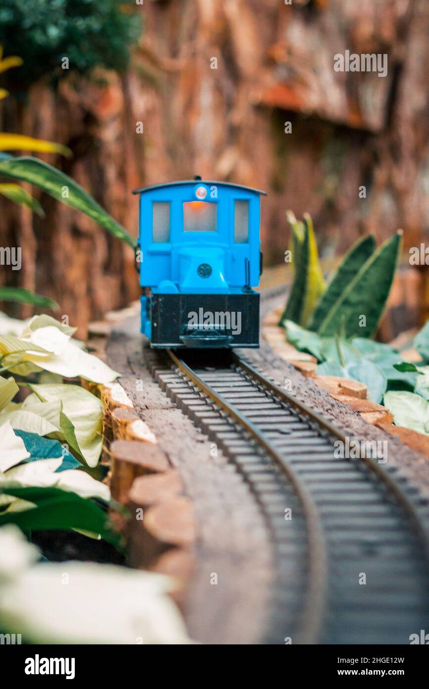 Blue model train on a track Stock Photo - Alamy