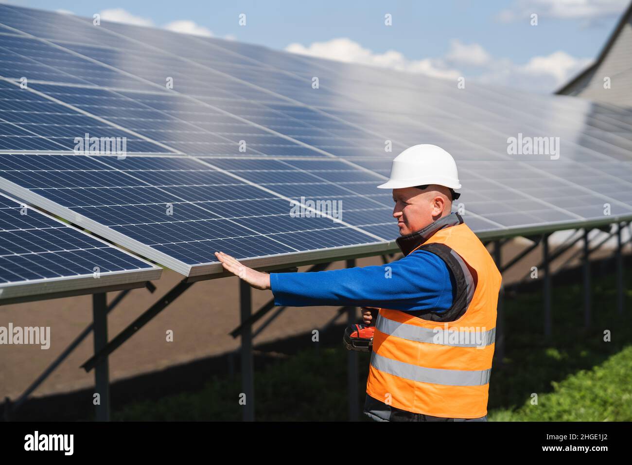 Solar power plant worker checks the condition of the panels Stock Photo ...